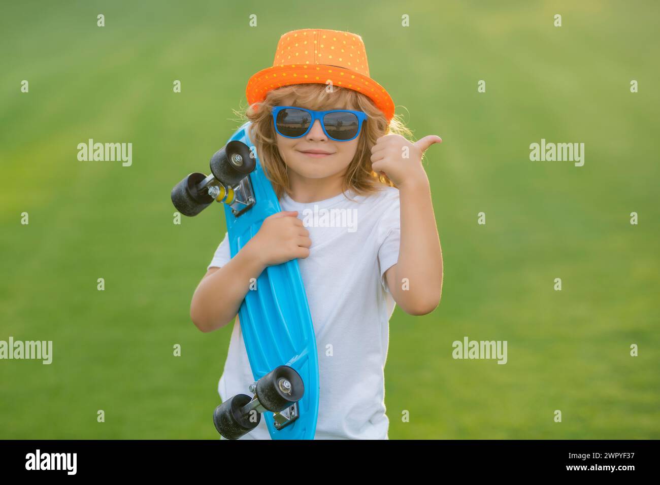 Child boy holding longboard on pink background. Kid with pennyboard ...