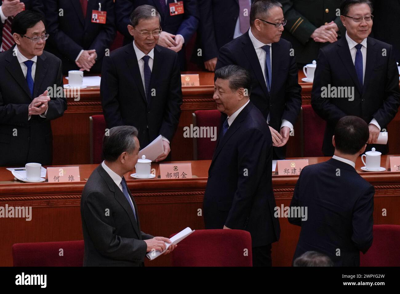 Chinese President Xi Jinping, center, walks by delegates after ...