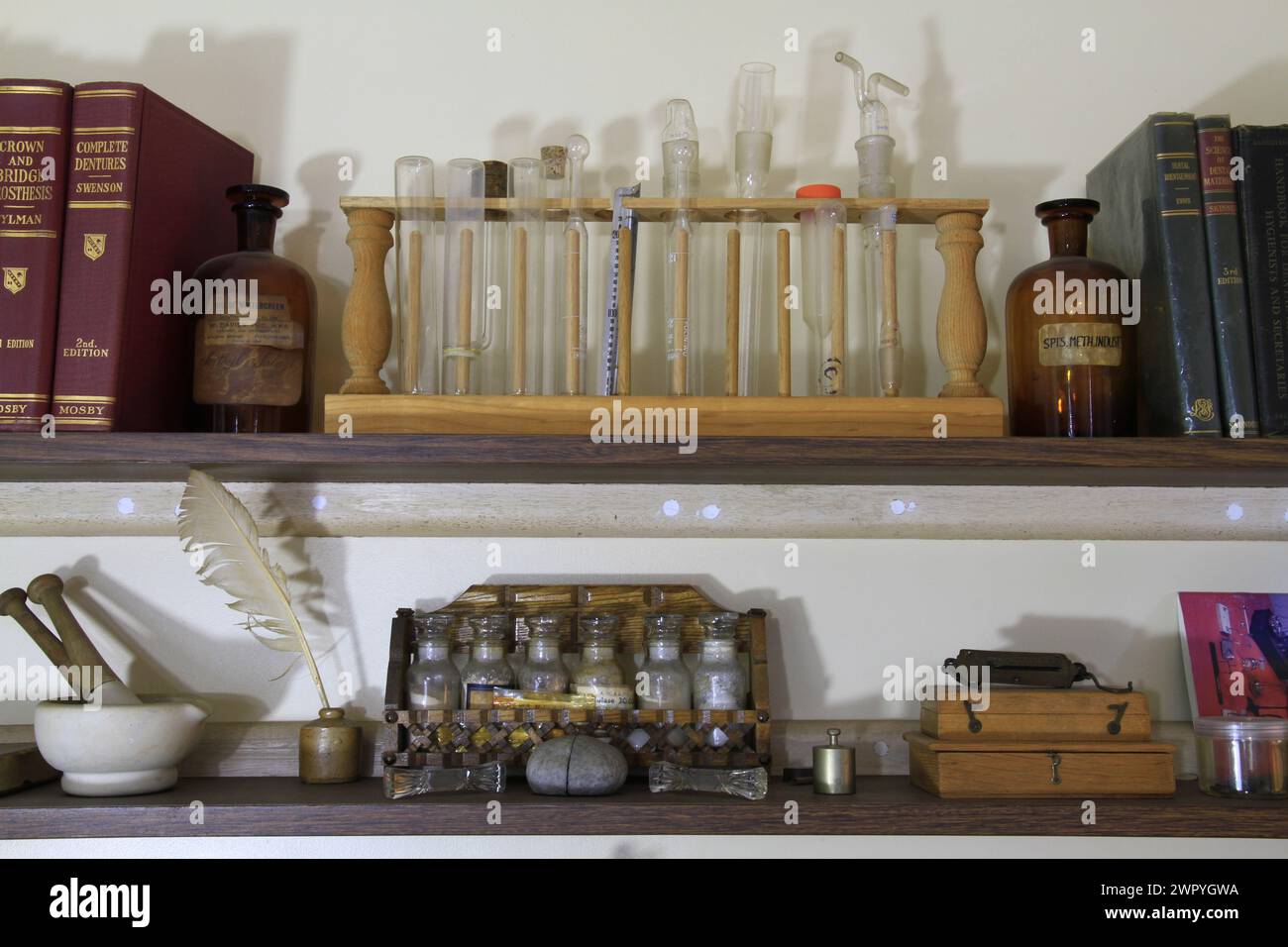 A historic display of chemical bottles, glassware and medical textbooks ...