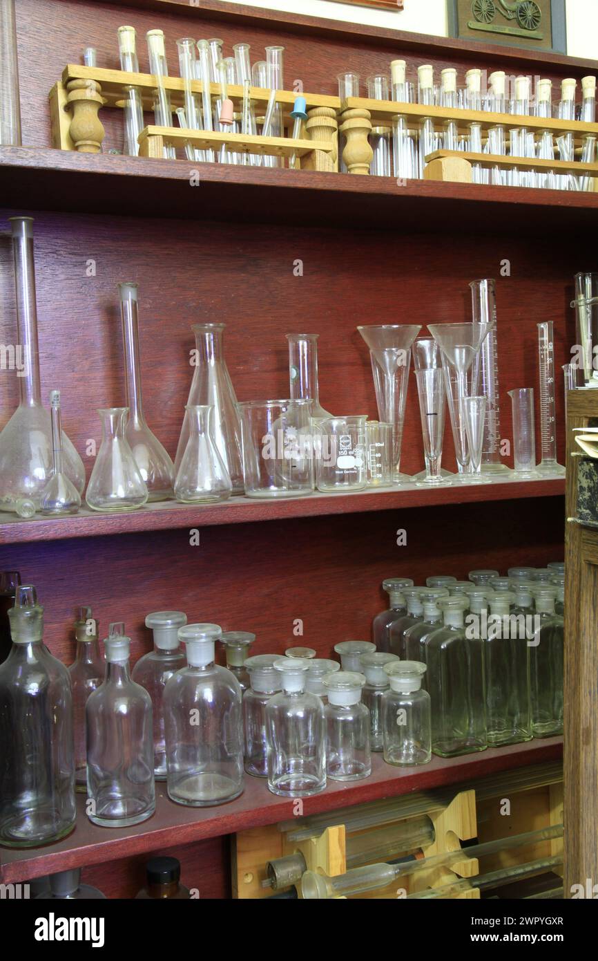 A collection of chemical glassware is displayed in a bookcase Stock ...