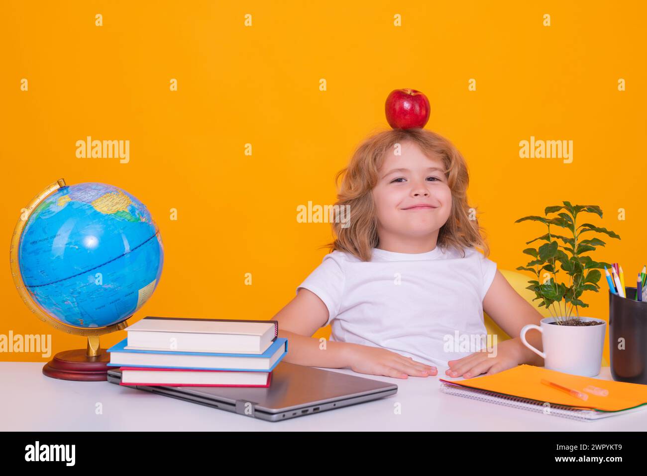 Funny pupil with apple an head. School and education concept. Portrait ...