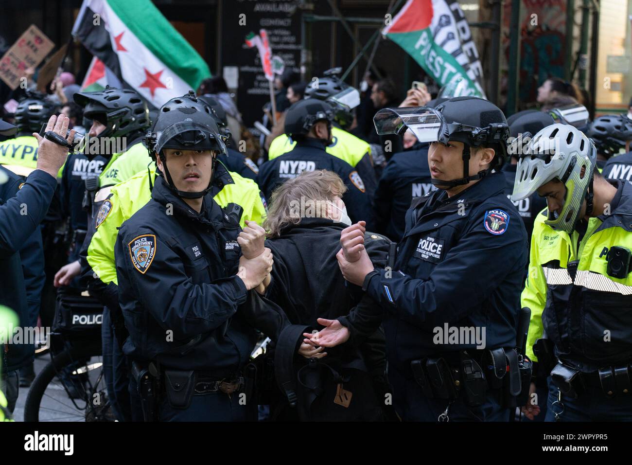 Manhattan, United States. 08th Mar, 2024. NYPD officers arm lock an ...