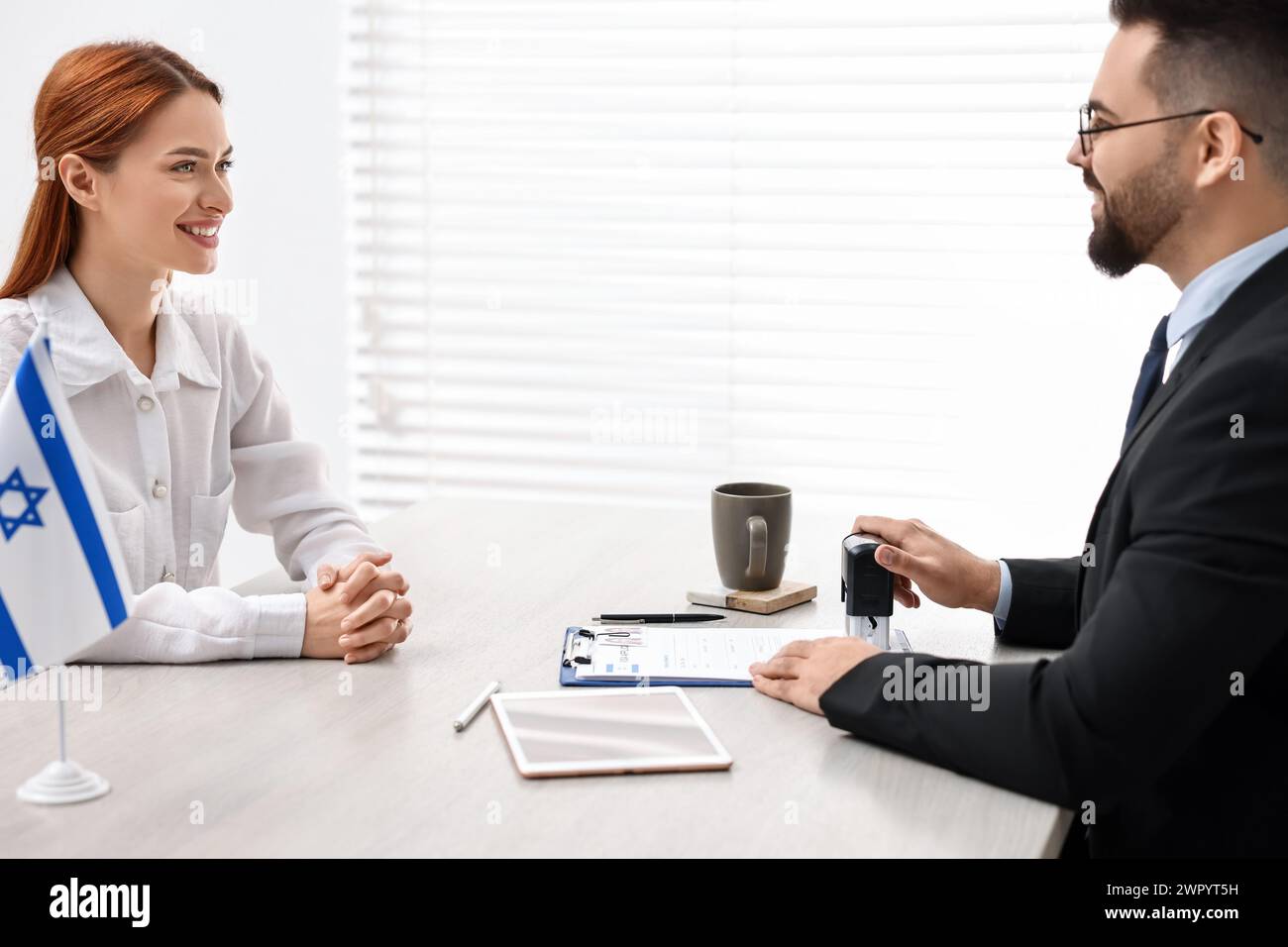 Immigration to Israel. Embassy worker approving visa application form ...