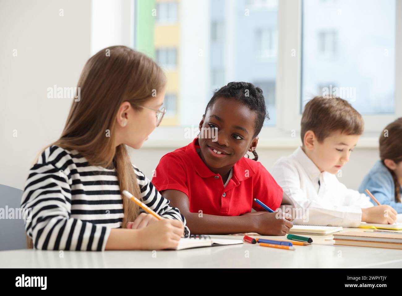 Cute children studying in classroom at school Stock Photo - Alamy