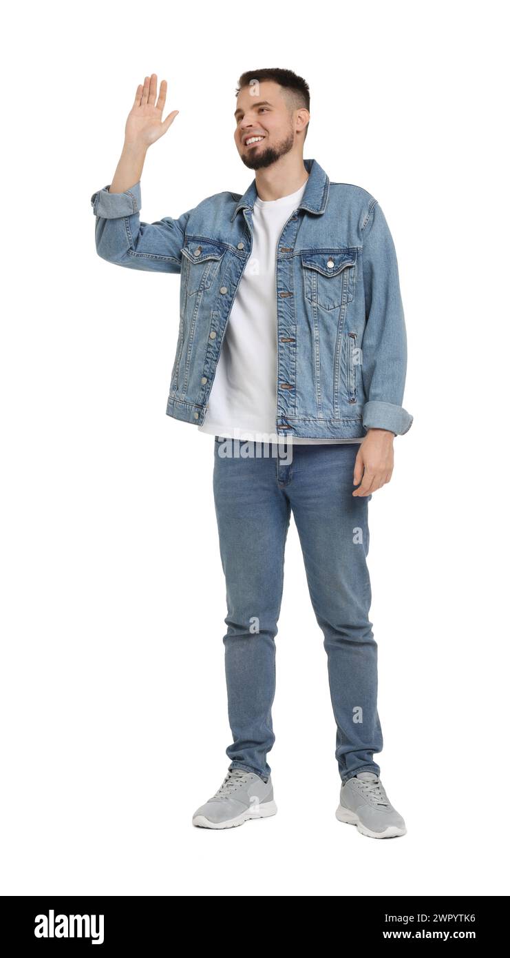 Man in denim clothes waving hand on white background Stock Photo - Alamy