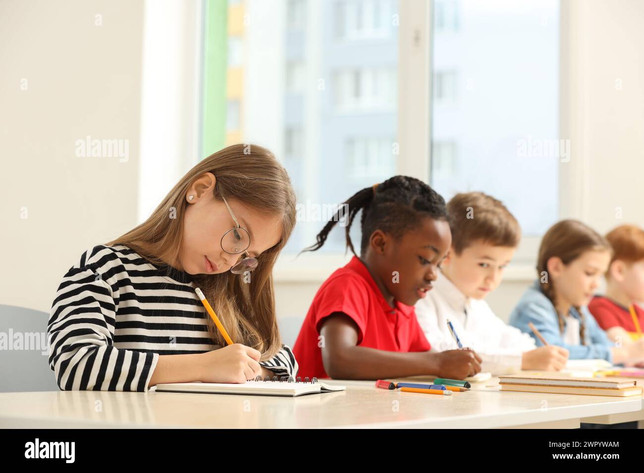 Cute children studying in classroom at school Stock Photo - Alamy