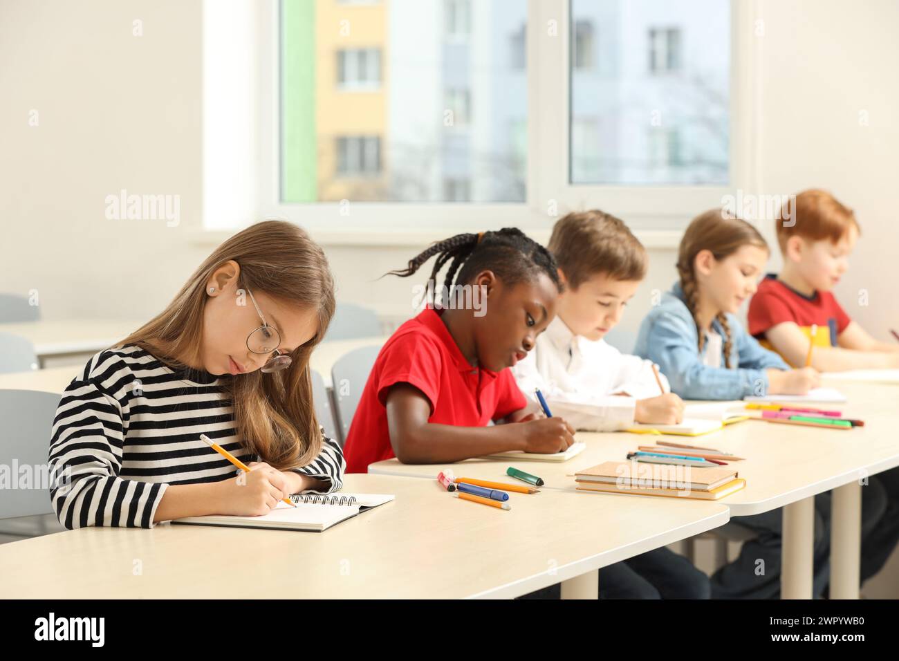 Cute children studying in classroom at school Stock Photo - Alamy