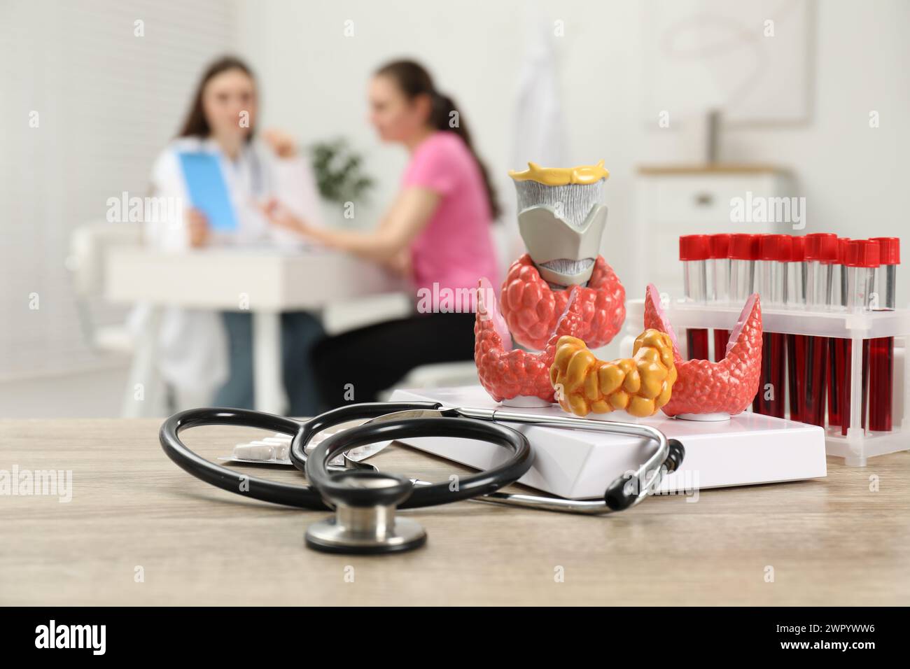 Endocrinologist examining patient at clinic, focus on stethoscope and ...