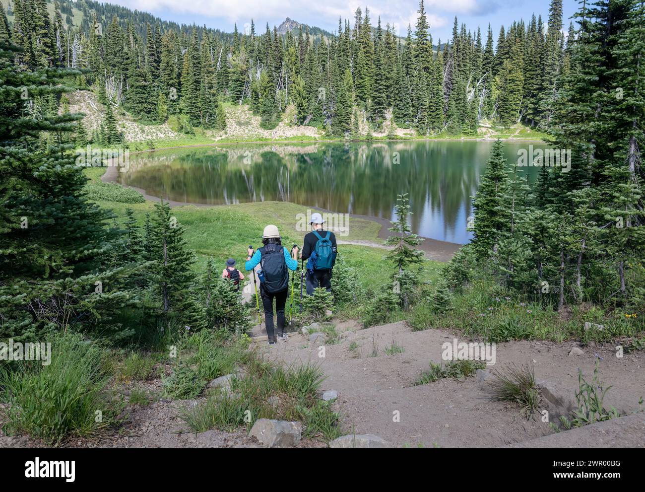 Three people hiking Shadow Lake Trail. Sunrise area. Mount Rainier ...
