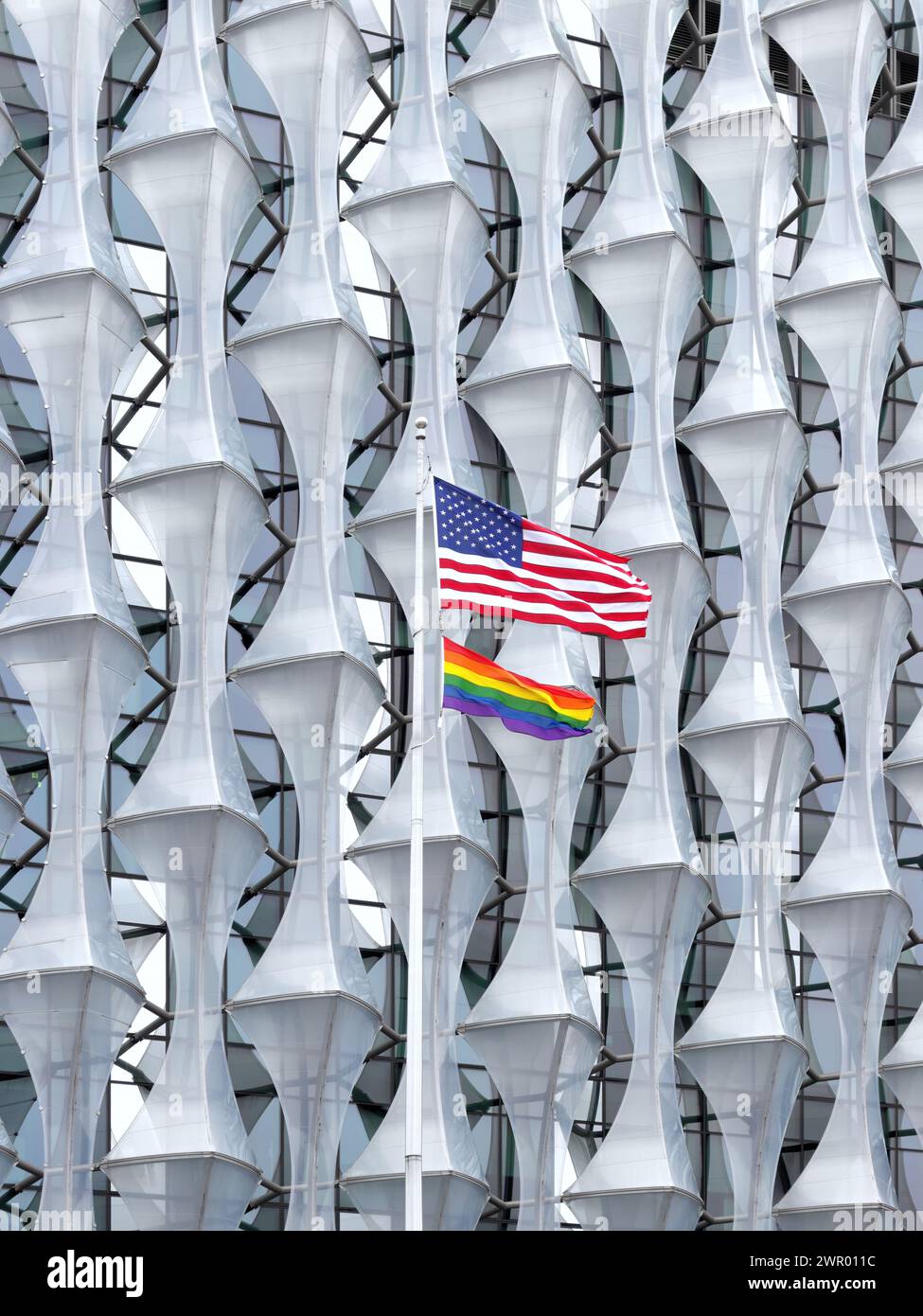 American and rainbow flags waving at the Embassy of the United States ...