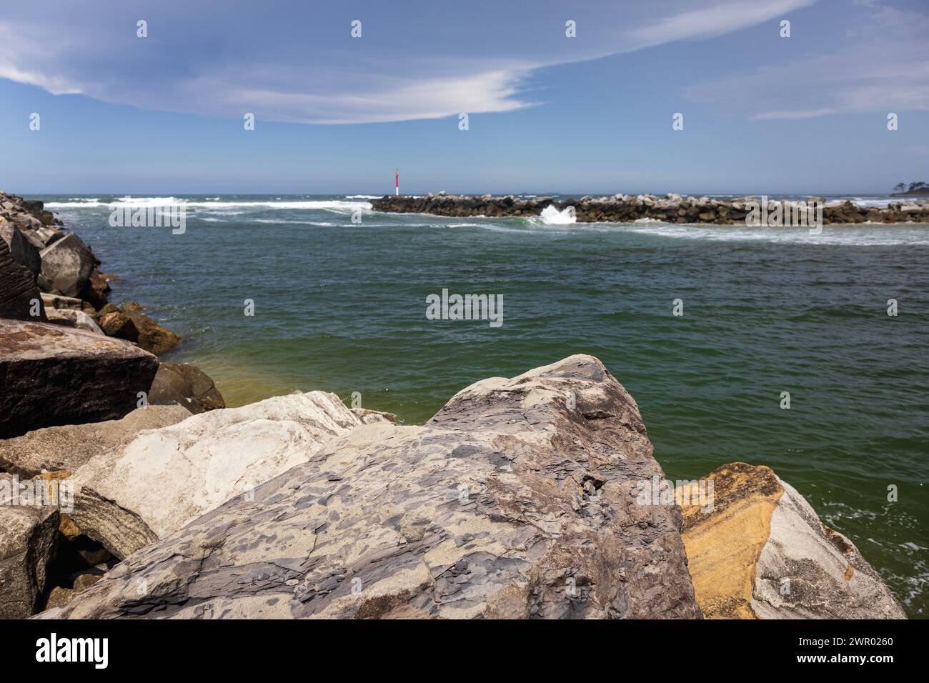 Big rocks and ominous storm clouds in sky over water at breakwall on ...