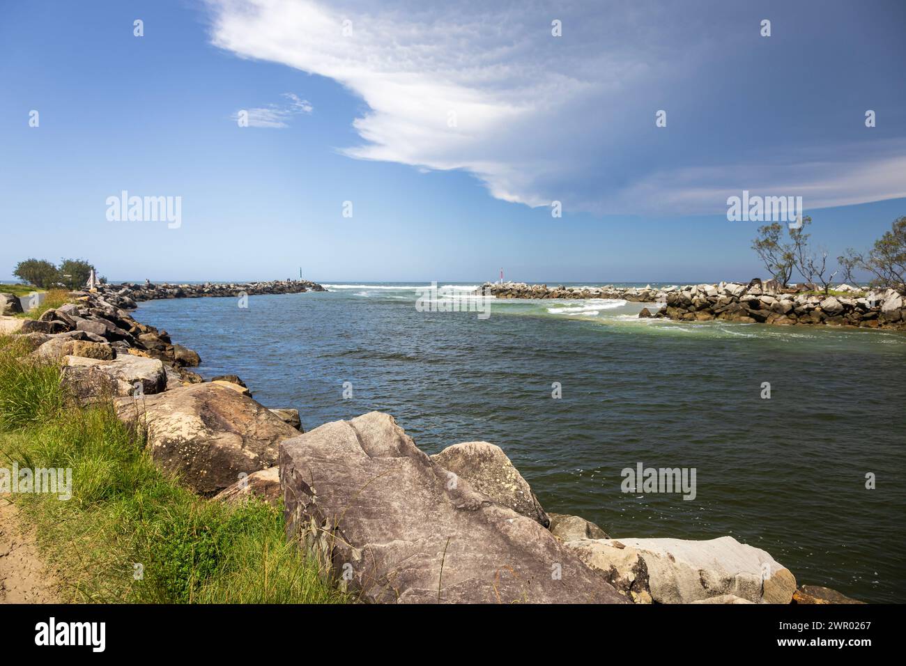 Big rocks and ominous storm clouds in sky over water at breakwall on ...