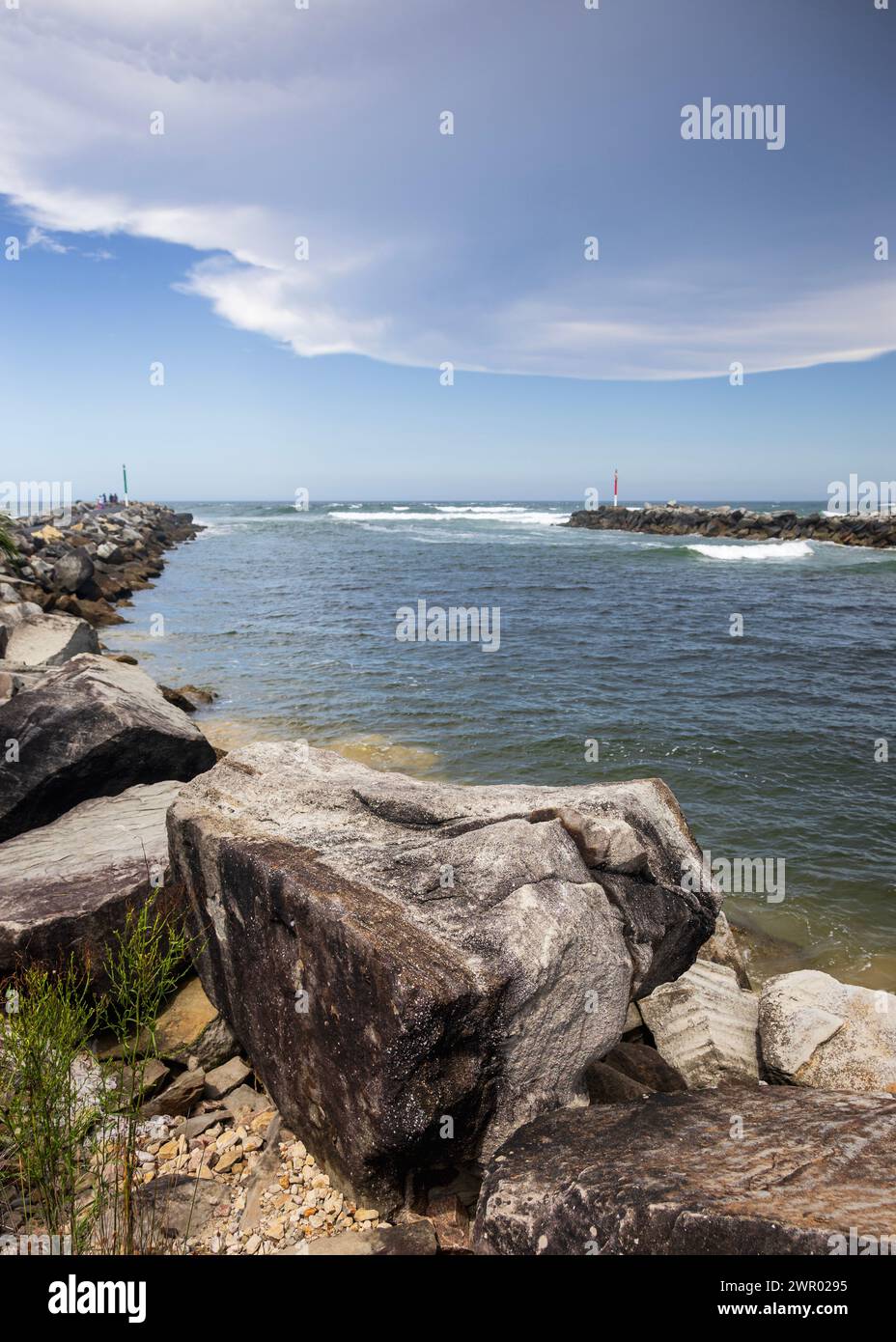 Big rocks and ominous storm clouds in sky over water at breakwall on ...