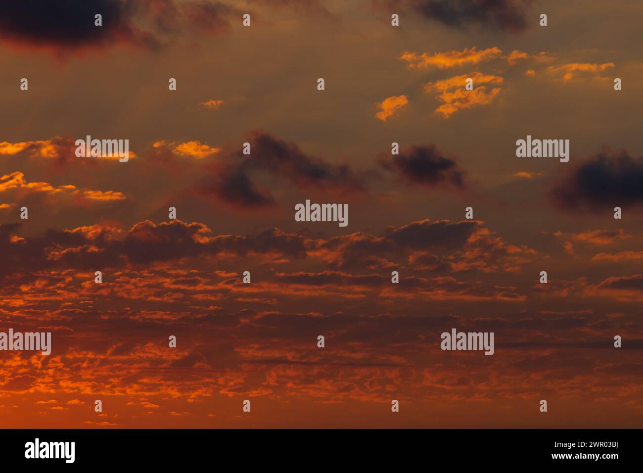 Sunset view with partly cloudy sky and sun rays. Dramatic sunset ...