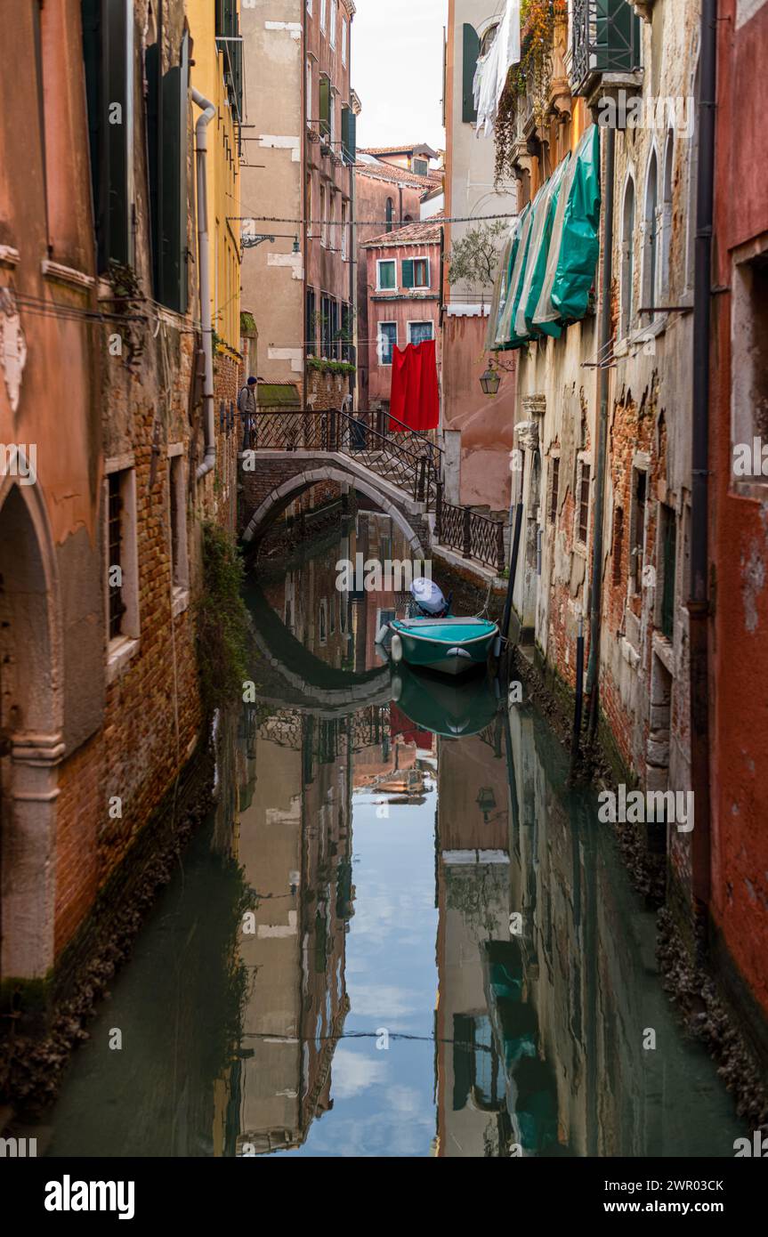 A small waterway on a quiet Sunday morning with a small boat and ...