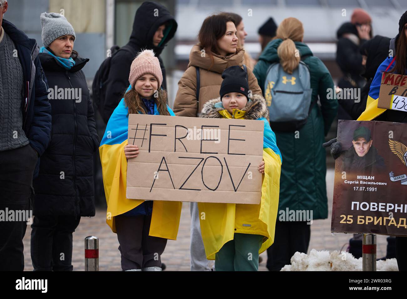 Ukrainian children wearing national flags show a banner "Free Azov" on ...