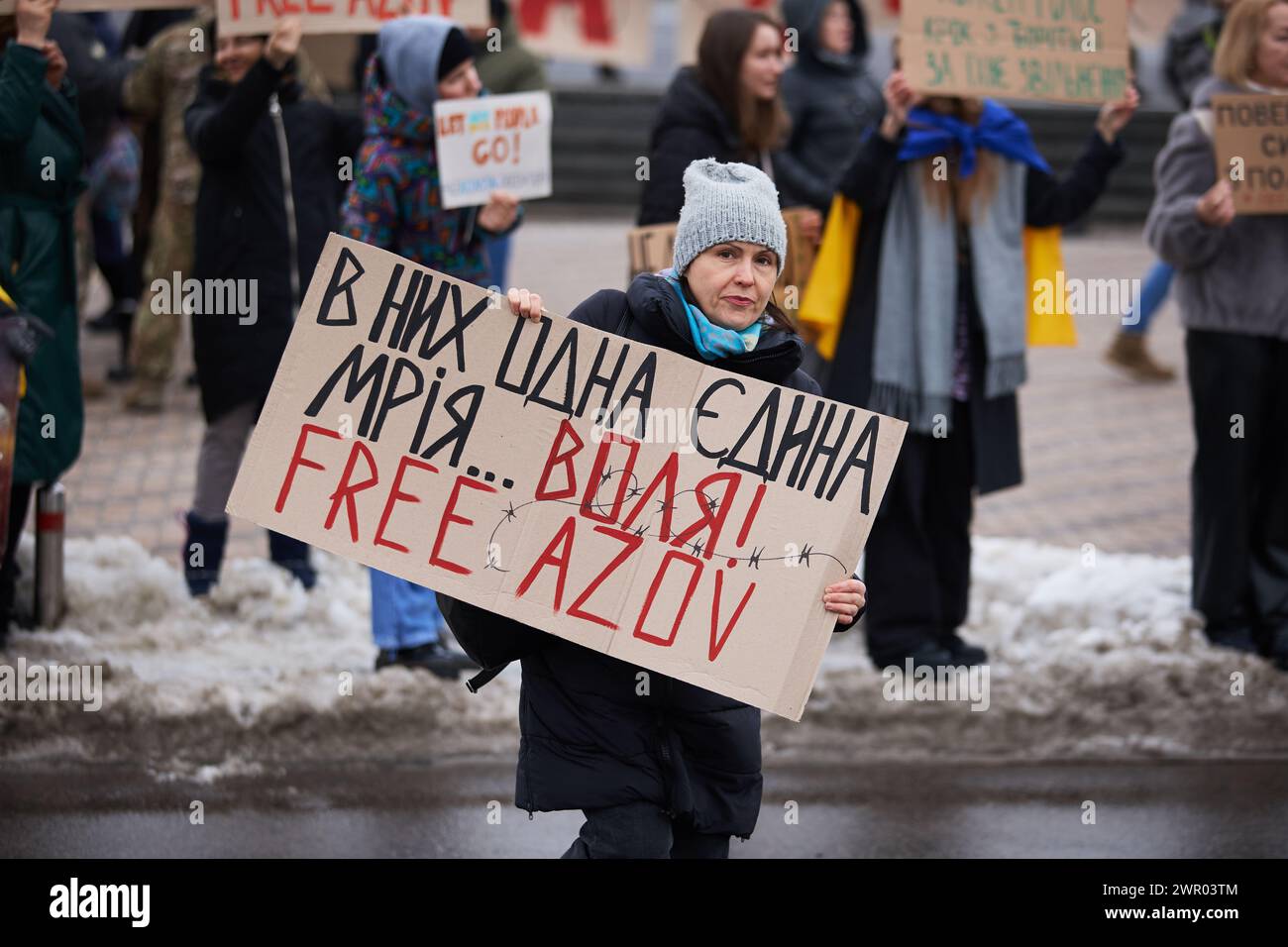Ukrainian woman walks with a banner "Their Only Dream Is Freedom. Free ...