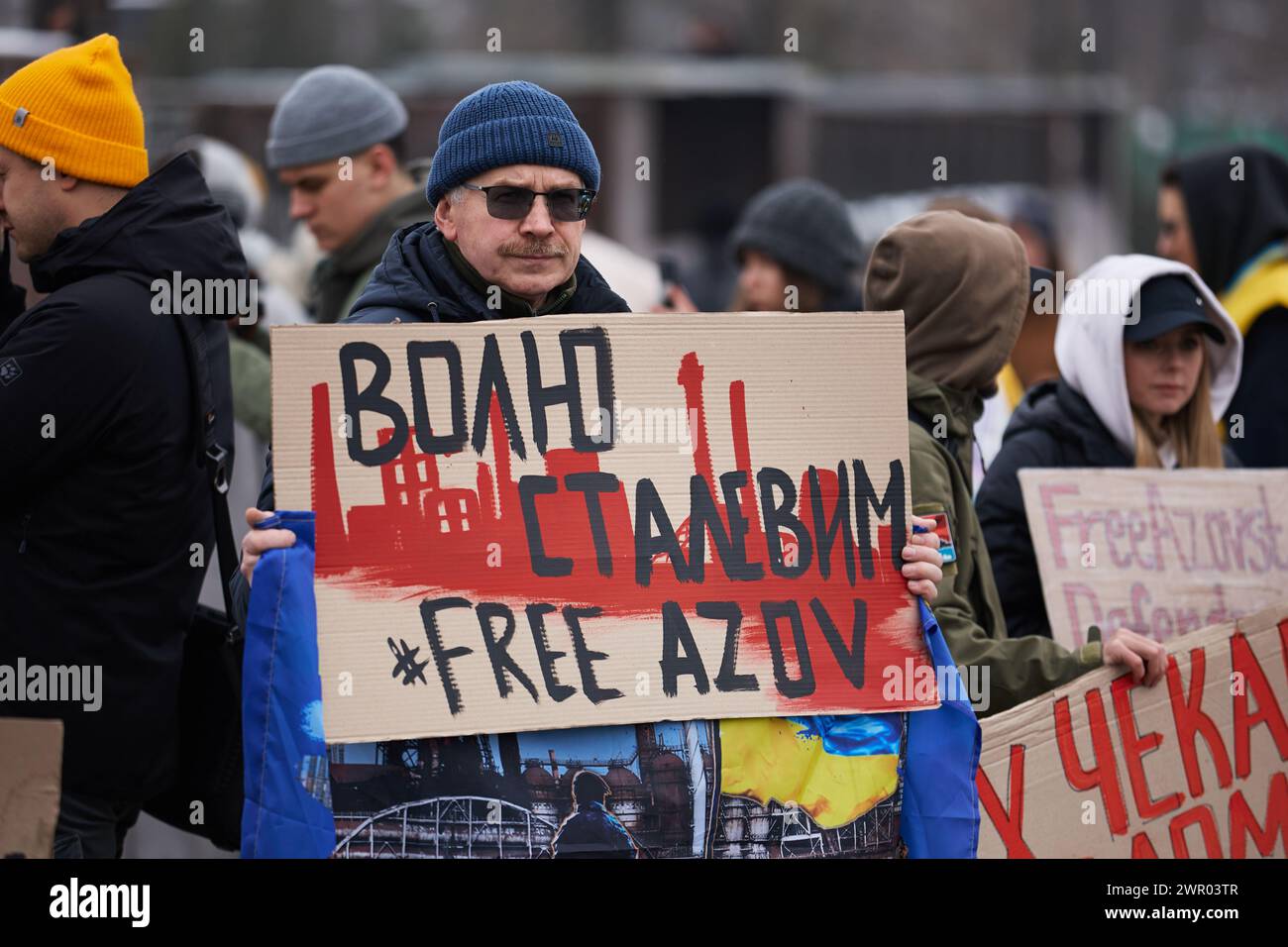 Senior Ukrainian man holds a banner "Freedom To The Steel People. Free ...