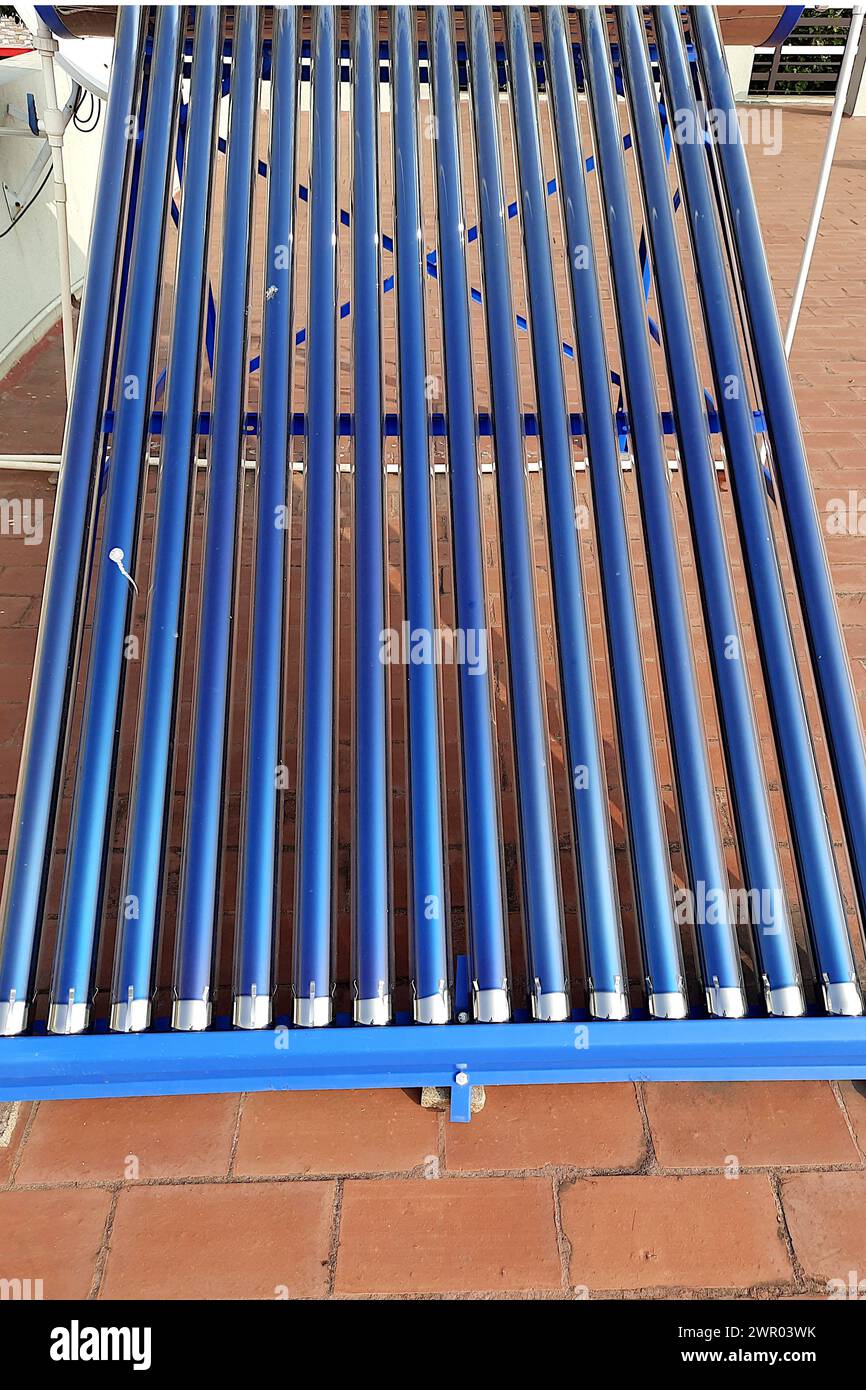 Close view of blue colour, tubular water heater panel on structural ...