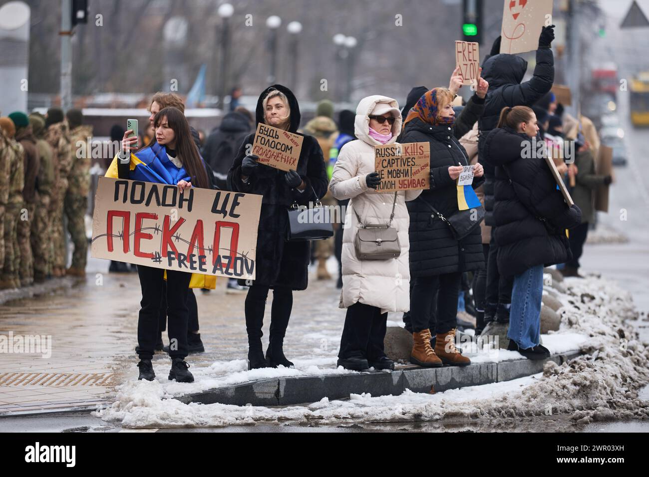 Ukrainian activists hold banners "Captivity Is Hell" on a public ...