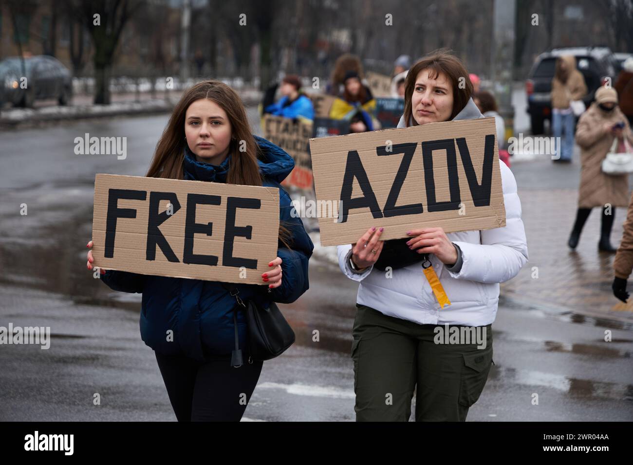Ukrainian females walk with banners "Free Azov" on a public demonstration dedicated to defenders ...