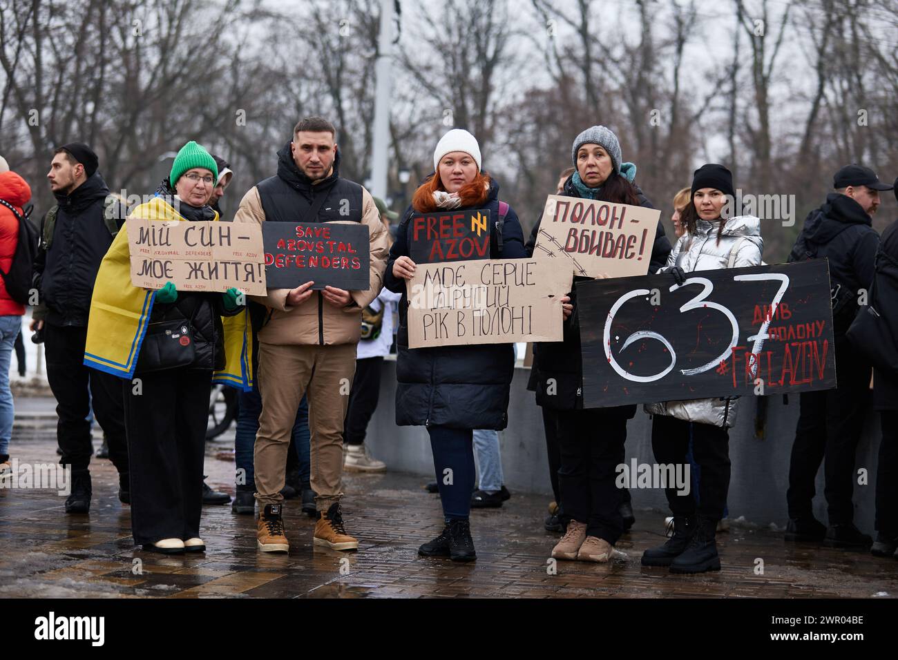 Relatives of captured Ukrainian soldiers hold banners "Free Azov" and ...