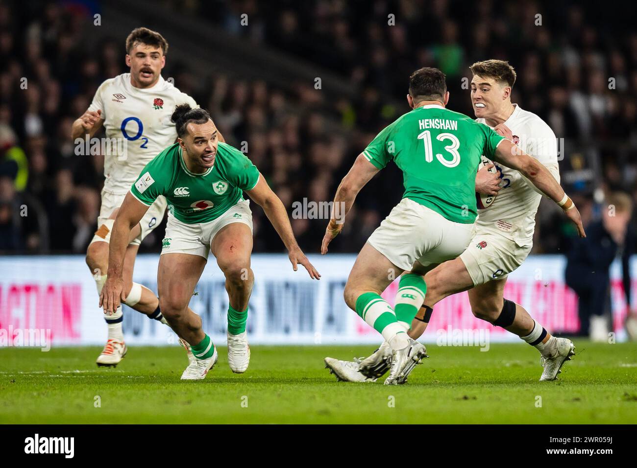 Tommy Freeman of England under pressure from Robbie Henshaw of Ireland ...