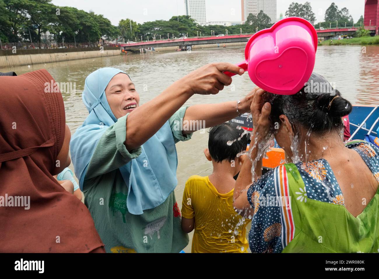 People bathe in the Cisadane River, ahead the holy fasting month of ...