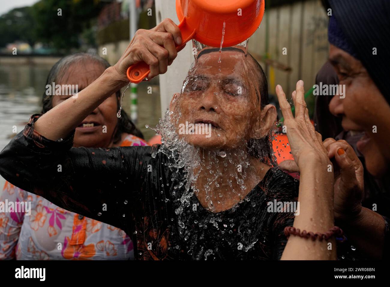 A women bathe in the Cisadane River, ahead of the holy fasting month of ...