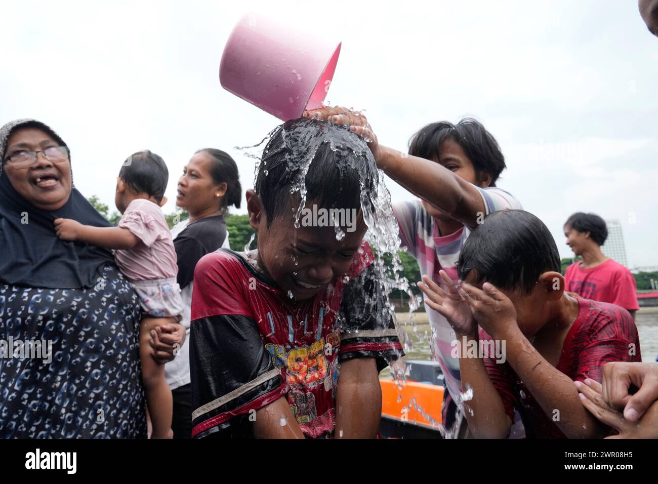 People bathe in the Cisadane River, ahead of the holy fasting month of ...