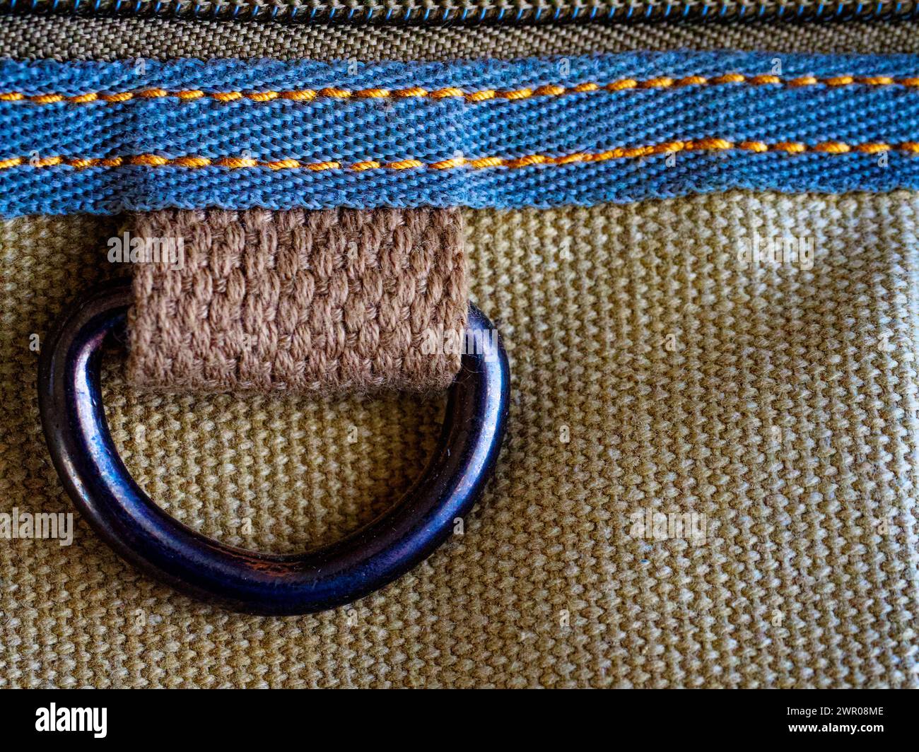 Denim with orange stitching and a fabric loop on a ring, placed on ...