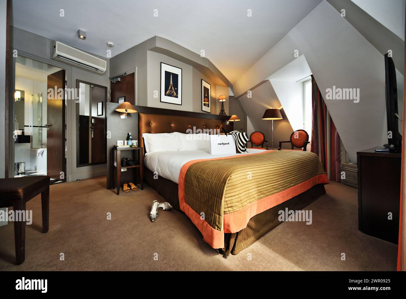 Paris, France, a spacious attic hotel room in decorated with framed ...