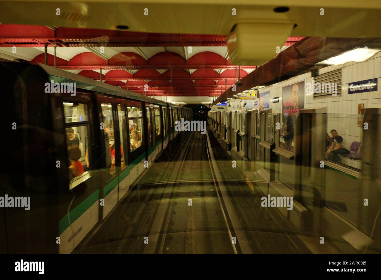 Looking out front window of a Paris Metro train as it enters Concorde ...