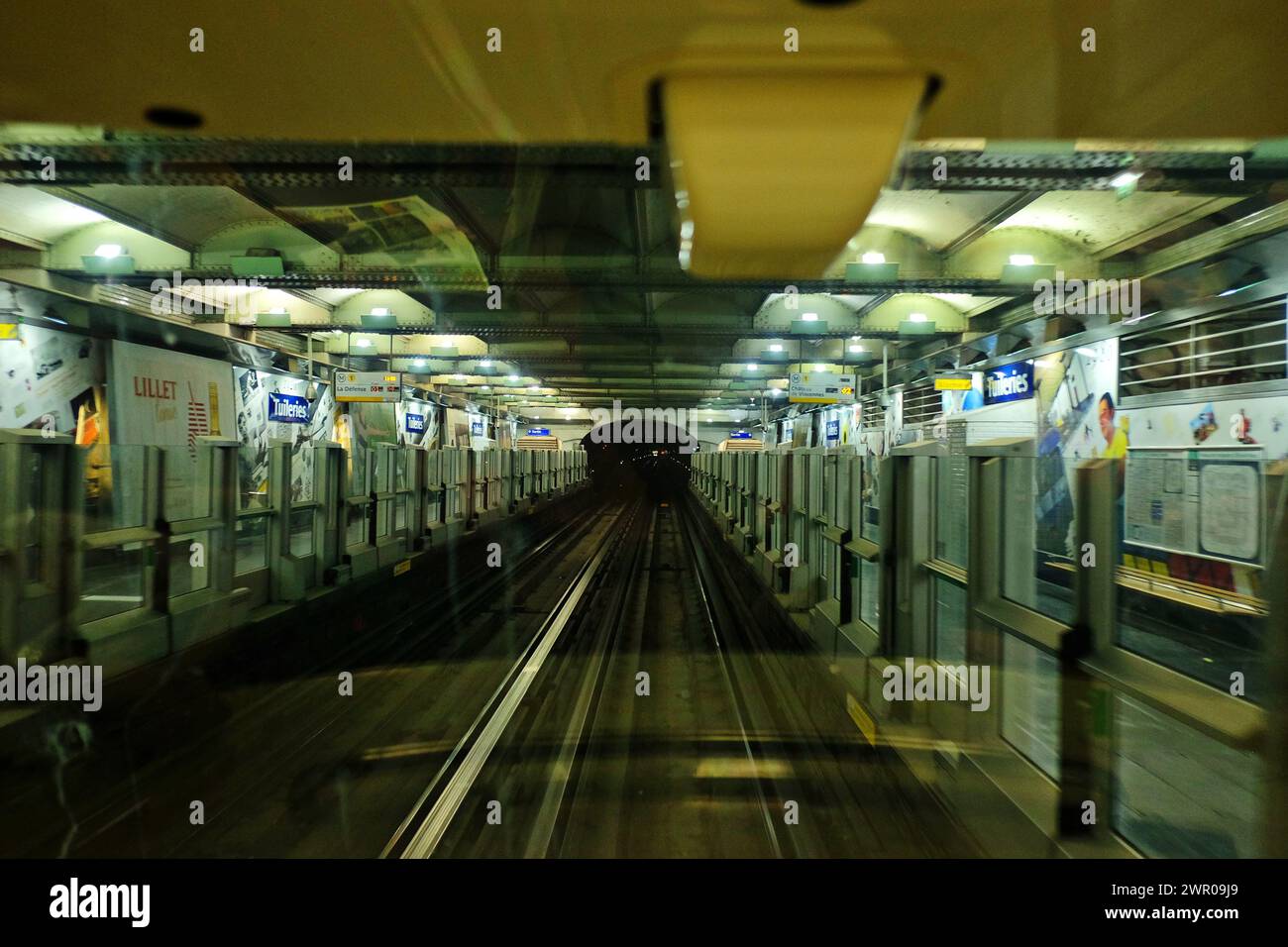 Looking out front windscreen of a Paris Metro train as it enters a ...