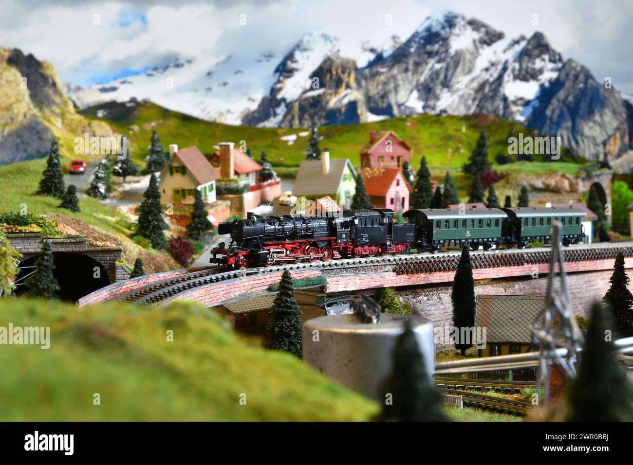 Miniature railway model with model steam locomotive train on a ...