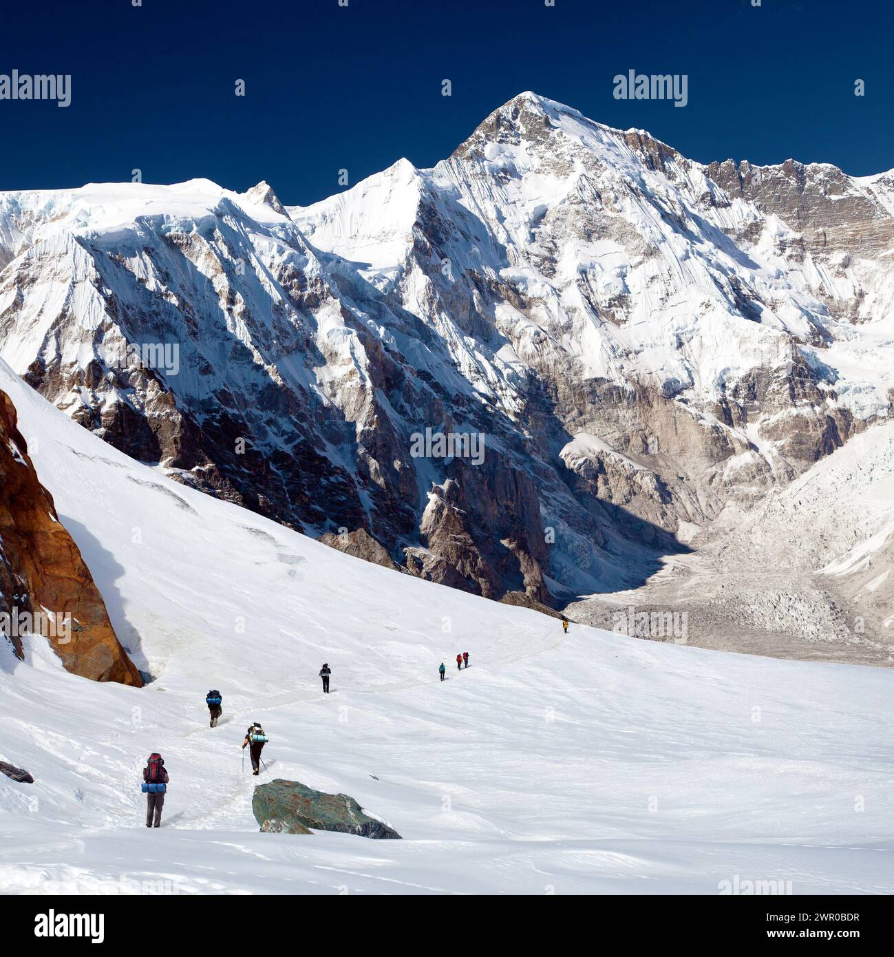 Mount Cho Oyu and group of hikers on glacier, way to Cho Oyu base camp ...