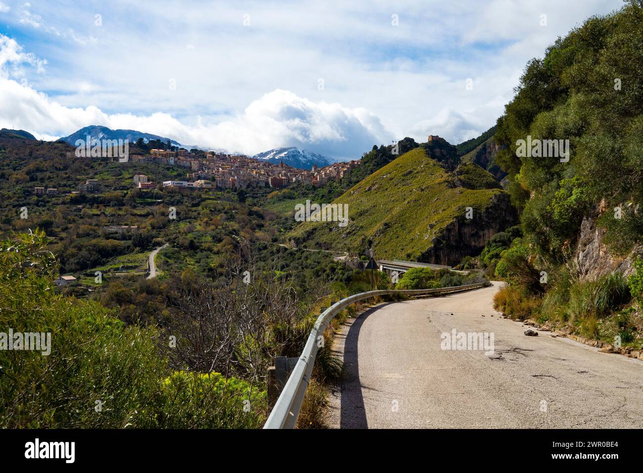 Country road and the village of Isnello on the italian island of Sicily ...