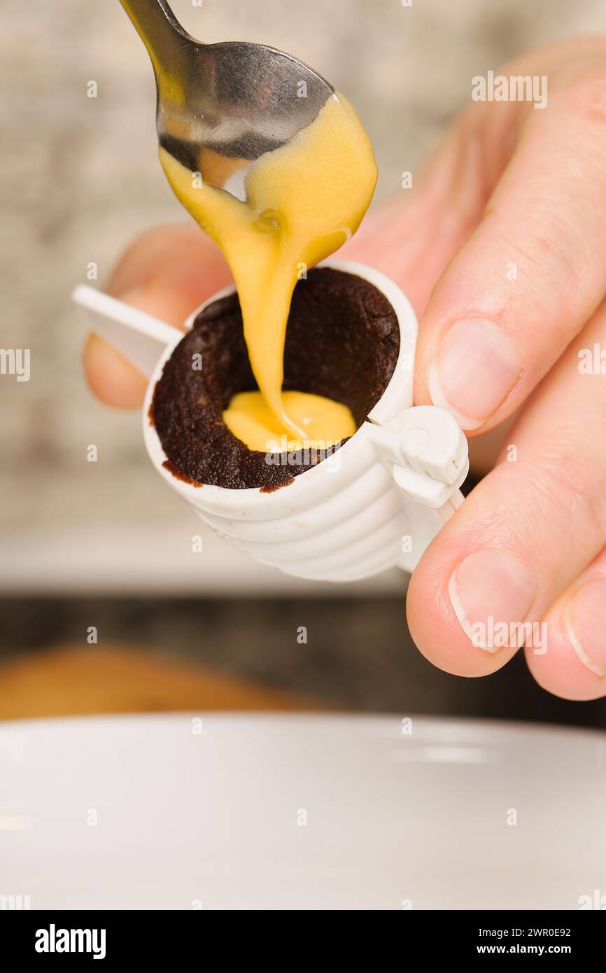 Filling of traditional christmas sweets bee hives with yolk creme Stock ...