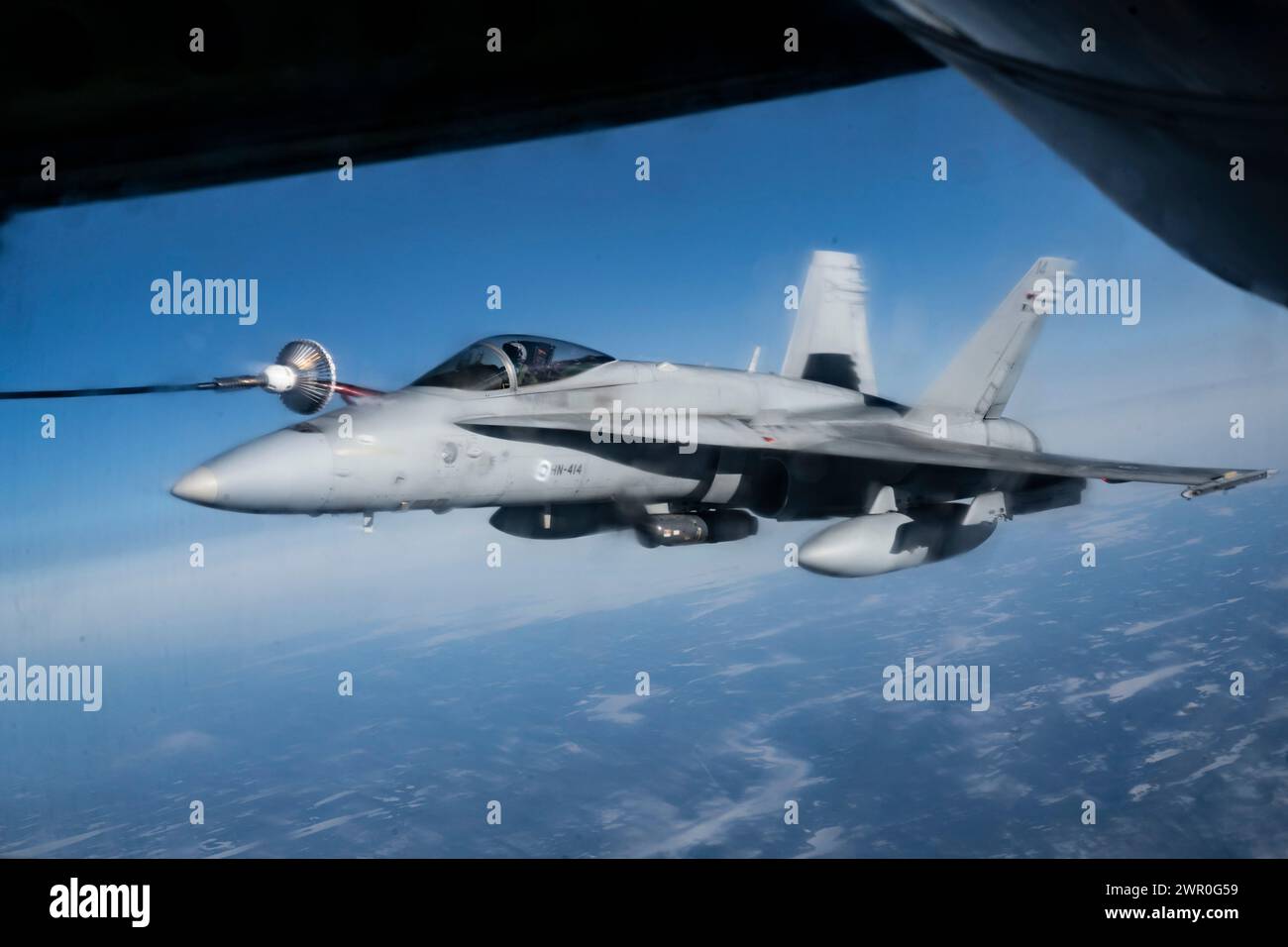 A Finnish Air Force F/A-18C Hornet receives air-to-air refueling from a ...