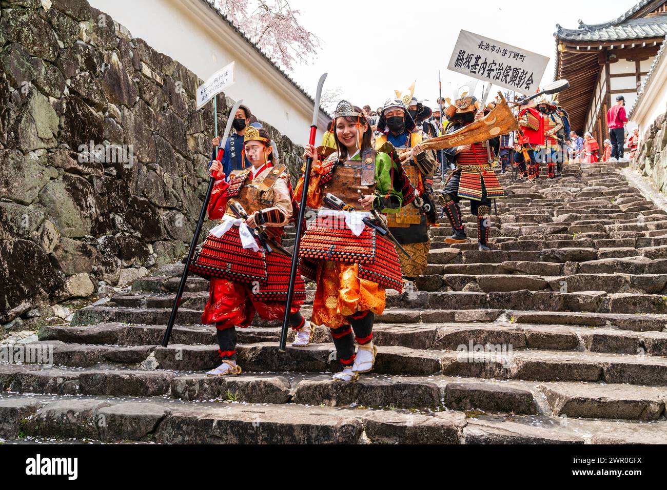 Two smiling young Japanese women dressed in Heian style samurai armour ...