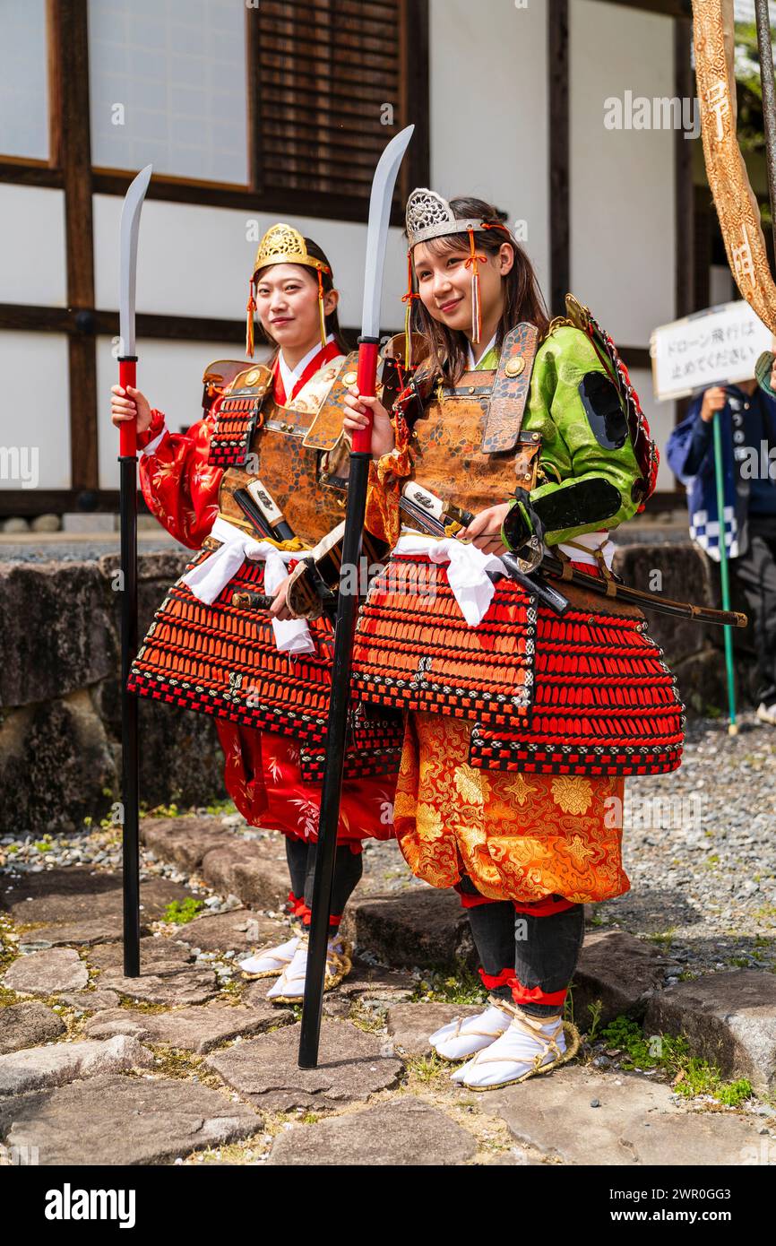 Two smiling young Japanese women dressed in Heian style samurai armour ...