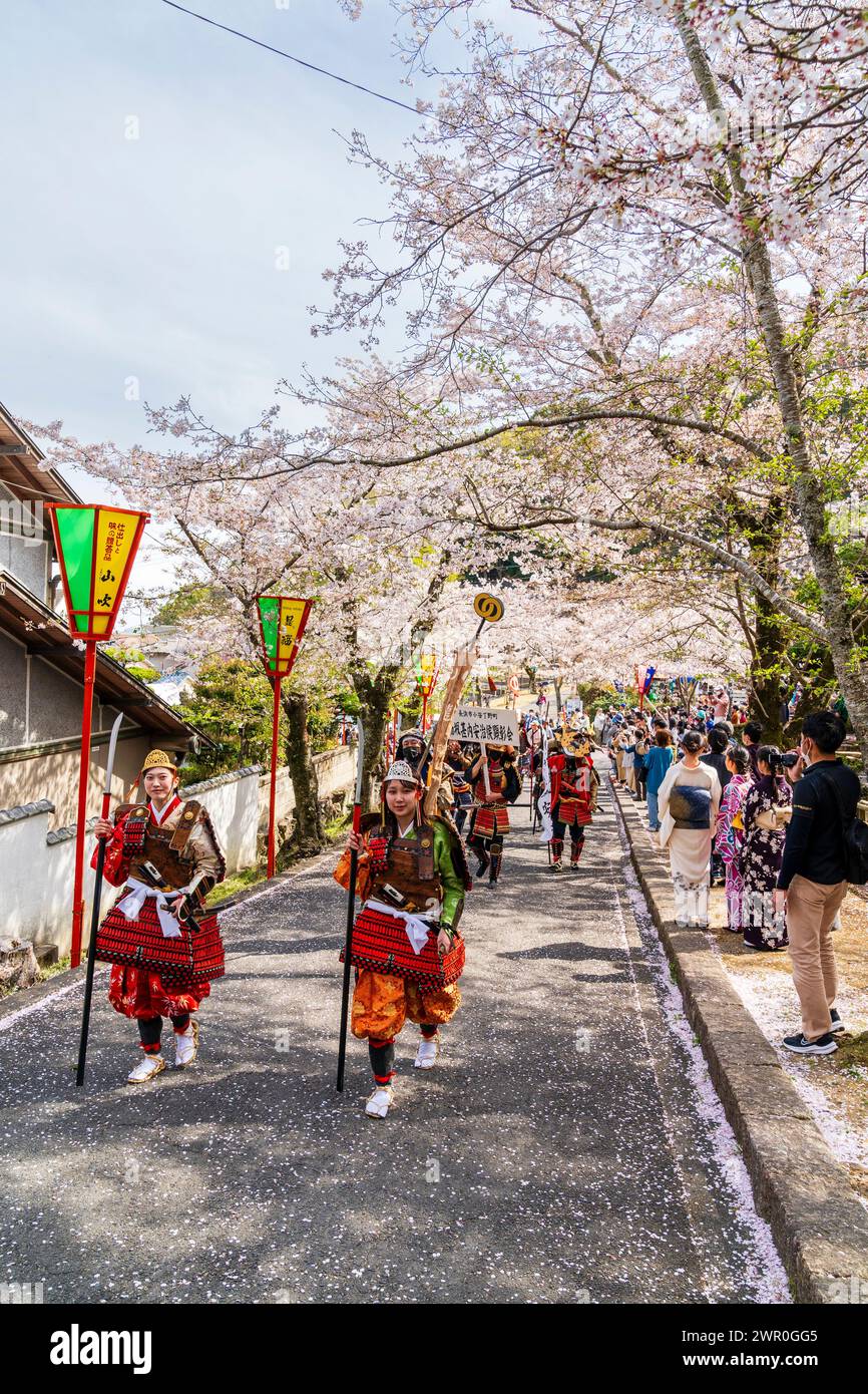 Tatsuno samurai parade under cherry blossom trees with two girls in ...