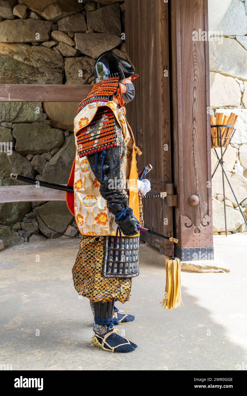Japanese man dressed as a samurai standing in the entrance to Tatsuno ...