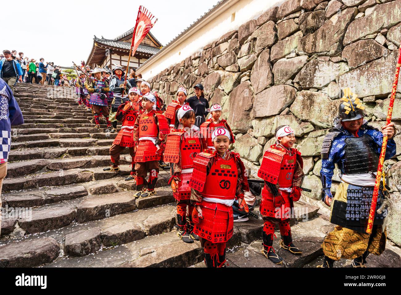 Young Japanese girls dressed in red armour as ashigaru soldiers waiting ...