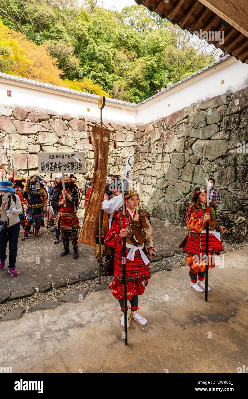 Two young Japanese women dressed in Heian red style samurai armour ...