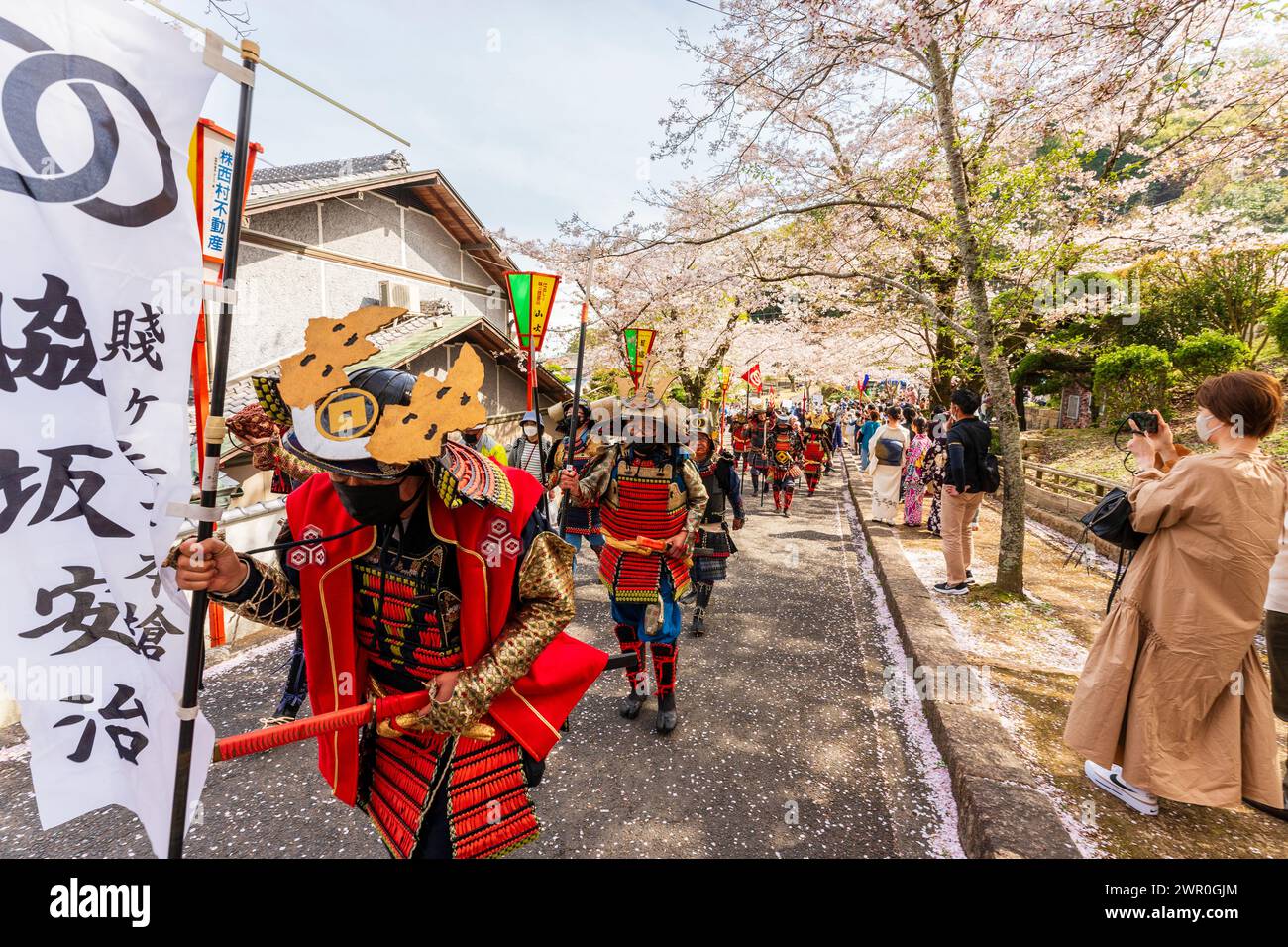 Tatsuno springtime samurai parade marching along a small road under ...