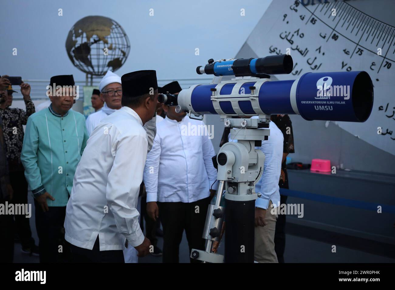 Islamic clerics use a telescope to search the sky for the new moon that ...