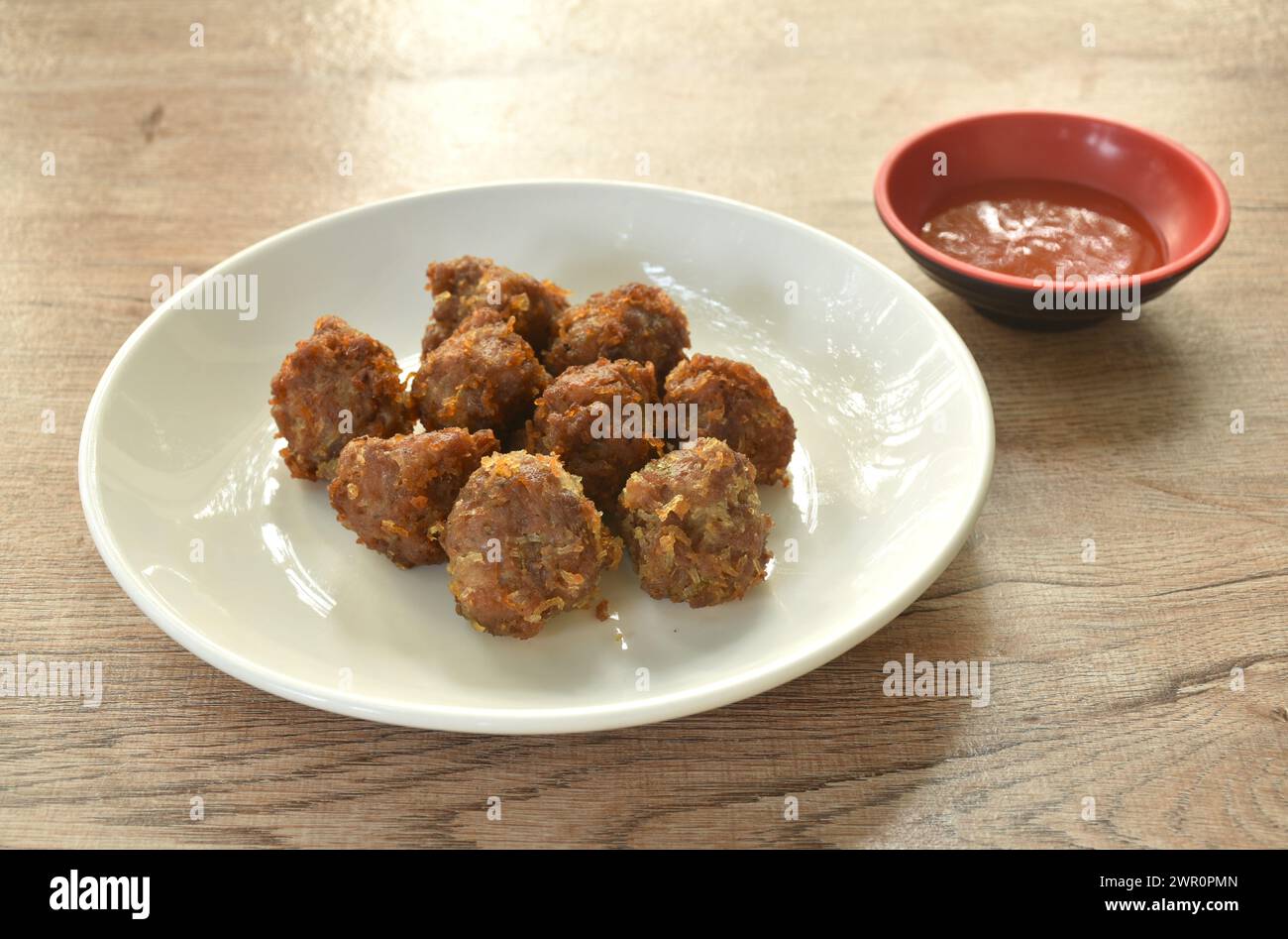 fried salt crispy chop pork with garlic dipping chili sauce on plate ...