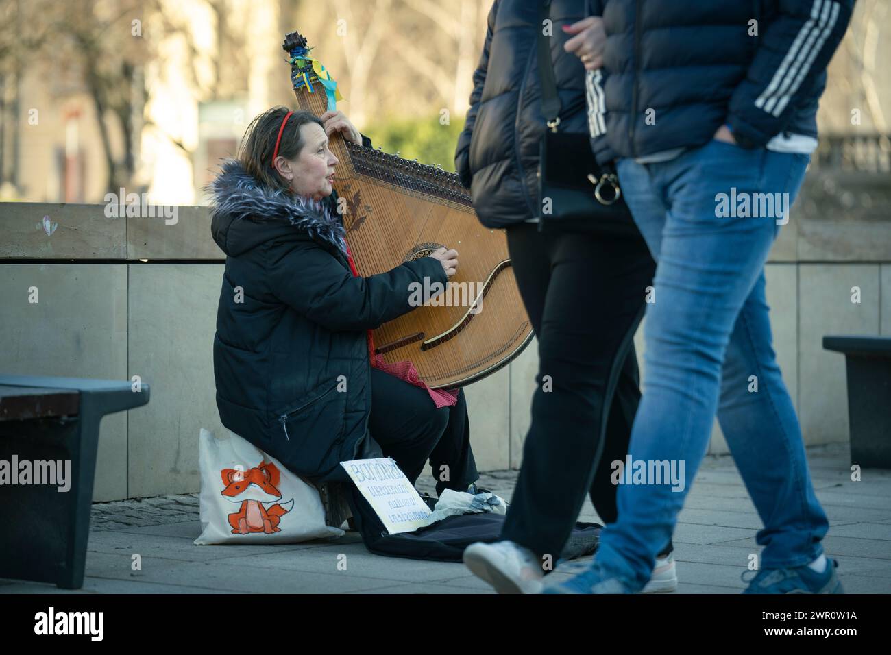 A woman singing in Ukrainian and playing a bandura folk instrument is ...