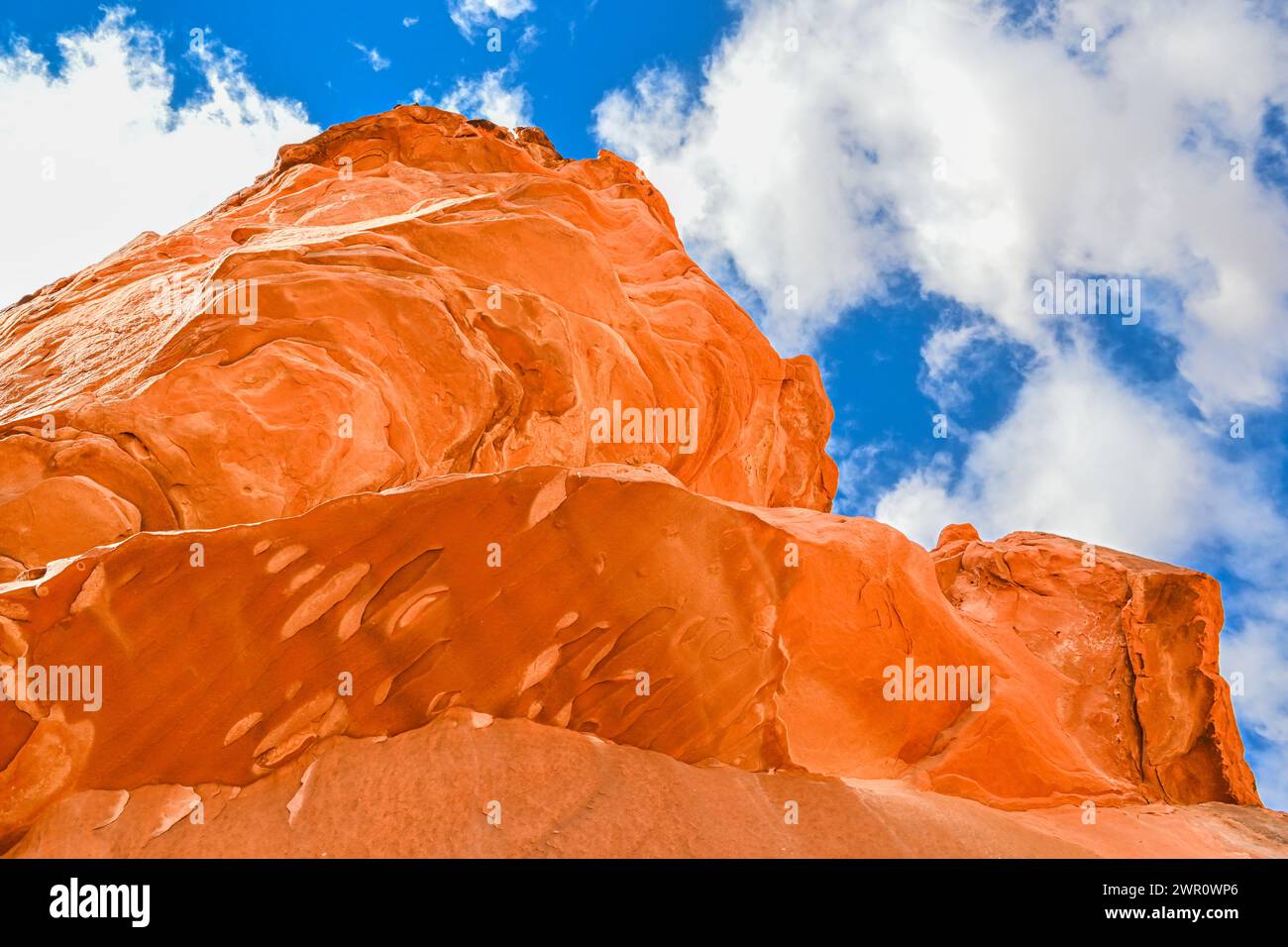 Red / orange Mojave sandstone with iron oxide set against blue sky ...